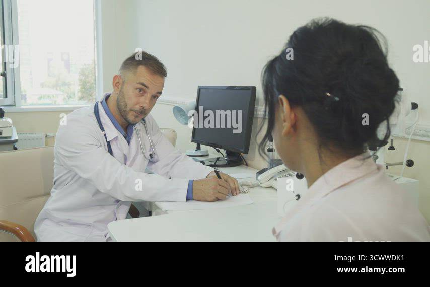 A calm doctor writes a medical certificate to his client Stock Video ...