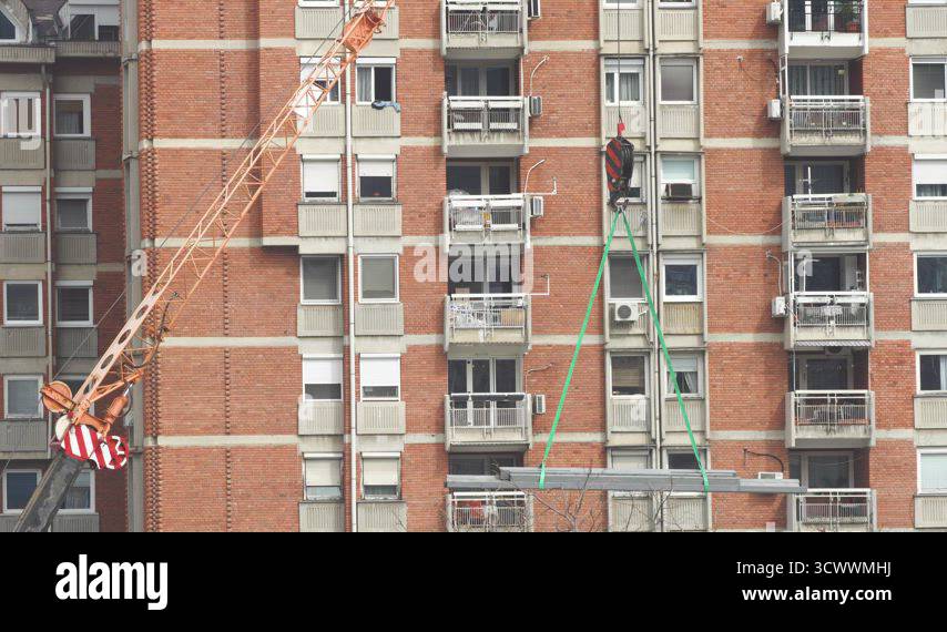 crane transporting metal rails on a construction site, generic ...