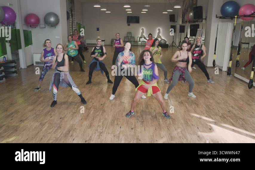 Girls dance zumba at a fitness center with an instructor. People ...