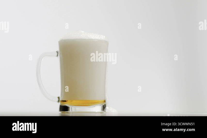 speed up footage of beer in a mug with a foam Stock Video Footage - Alamy