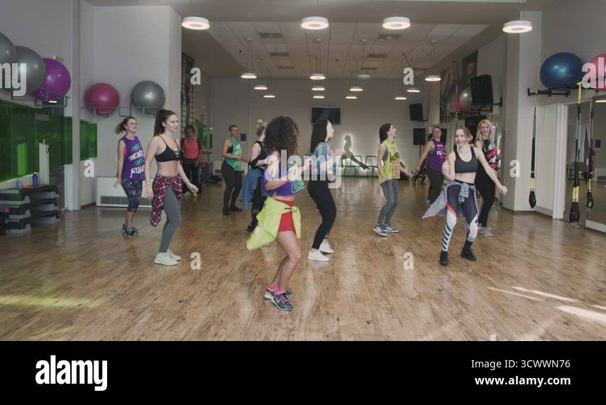 Girls dance zumba at a fitness center. People workout inside to stay in ...