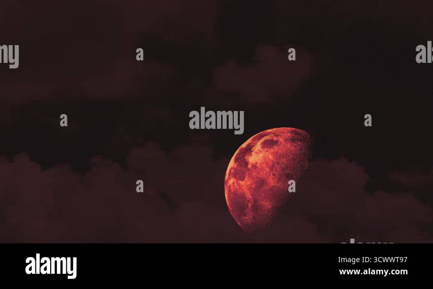 half red blood moon rise on the night sky and red cloud moving pass ...
