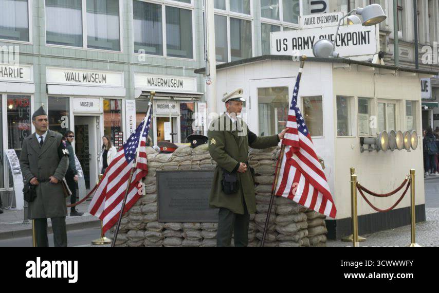 Checkpoint Charlie in Berlin with soldiers in uniform talking with ...