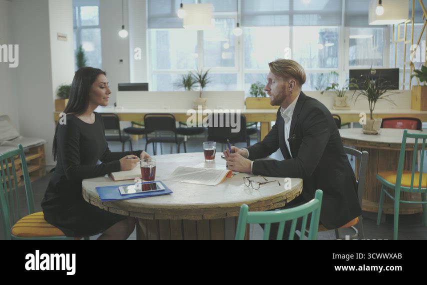 Business Partners at the meeting. Lady discusses strategy with a man ...