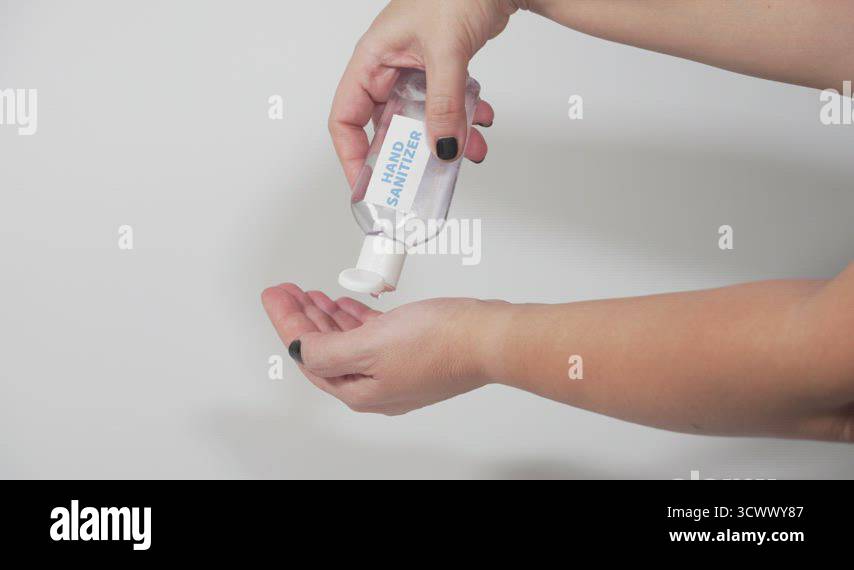 Cleaning hands with waterless, alcohol-based hand sanitizer antiseptic ...
