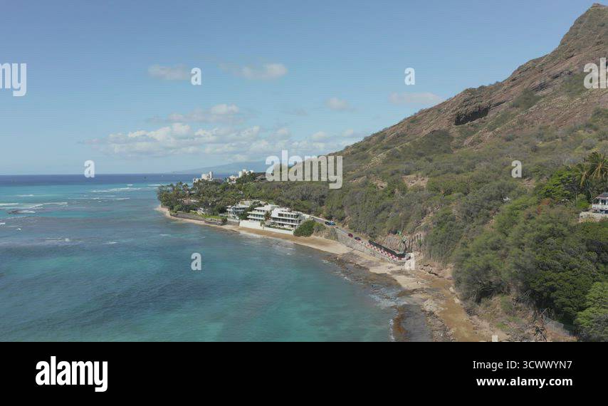Drone point of view rotating around the coastline by the Diamond Head ...