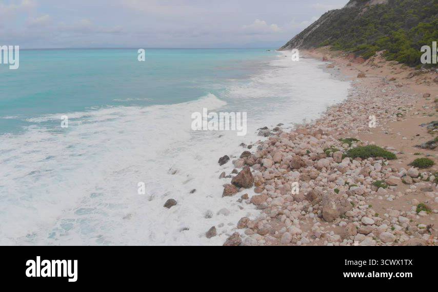 View to coastal cliff and wavy stormy ocean in cloudy day Stock Video ...
