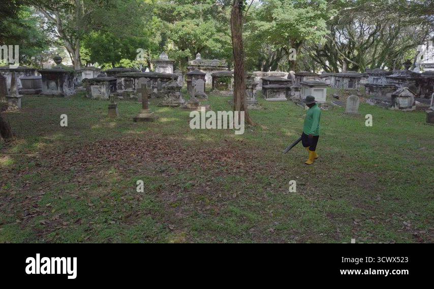 Protestant Cemetery is maintained by city council worker Stock Video ...
