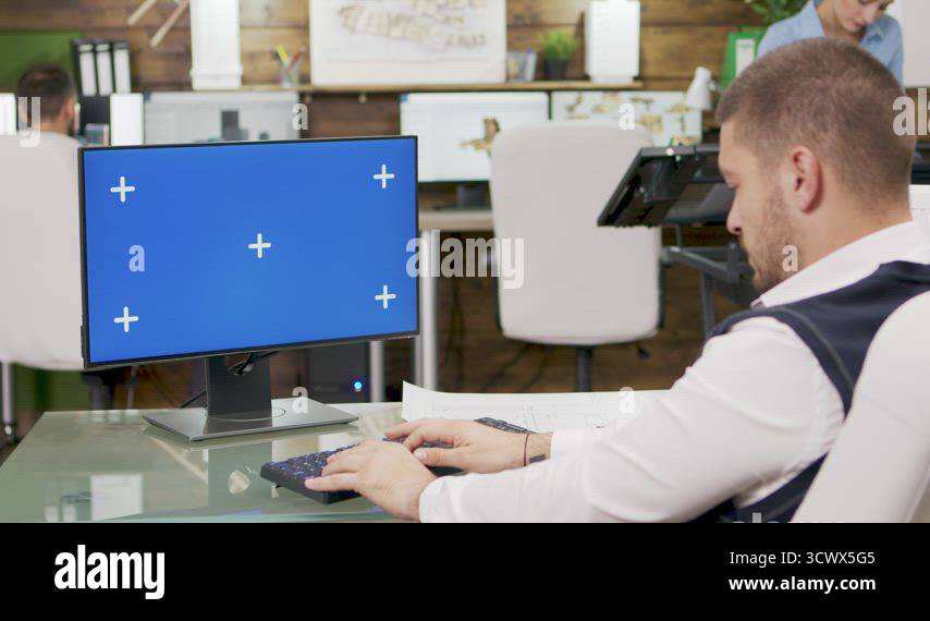 Architect typing on computer with blue screen Stock Video Footage - Alamy