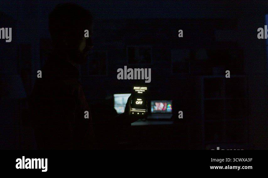 Man using a smart lights application to turn on the light bulbs in the ...