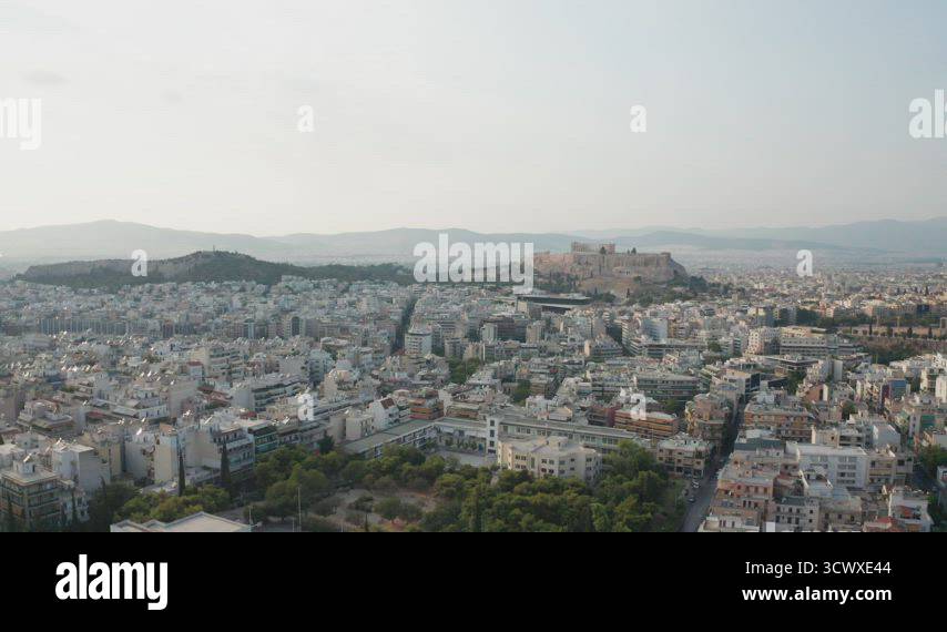 Aerial shot rising up from the ancient city of Athens to see Acropolis ...