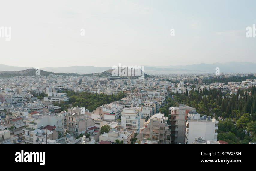 Aerial shot rising up from the ancient city of Athens to see Acropolis ...