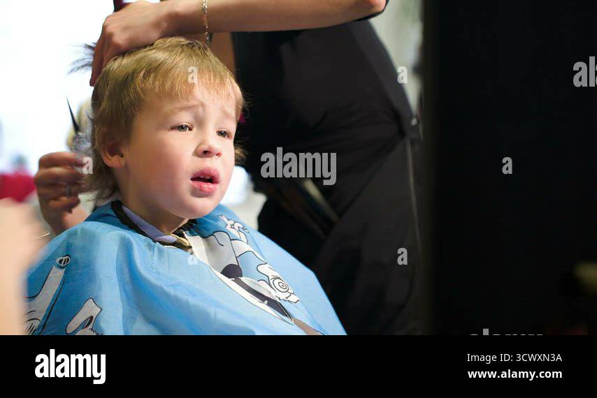 Boy taking off the cape while during haircut Stock Video Footage - Alamy