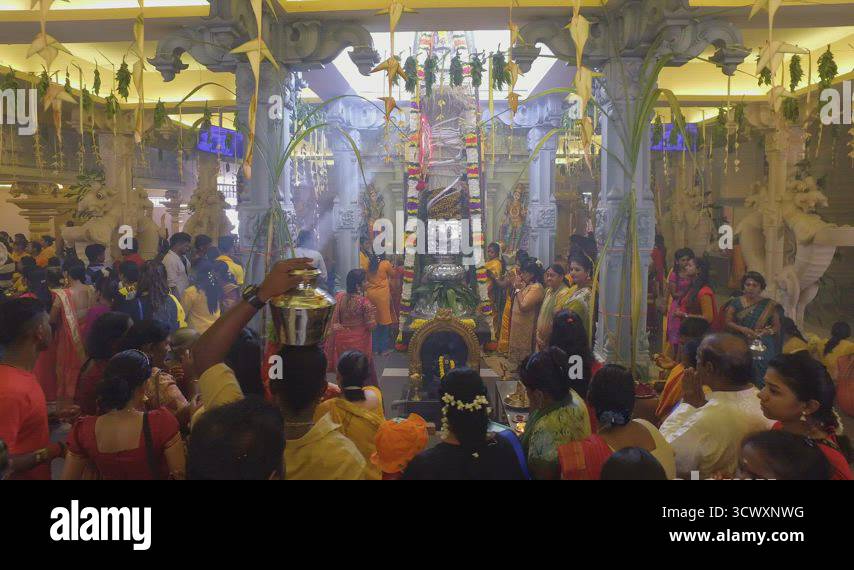 Devotees carry milk pot in the temple during Panguni Uthiram ...