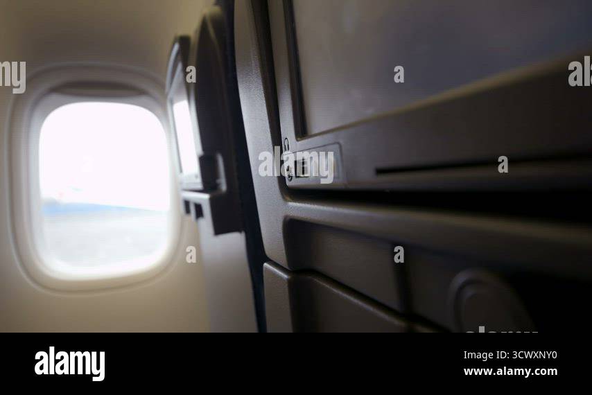 Inserting USB flash drive into socket of monitor in airplane Stock ...