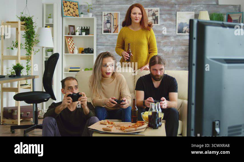 Young man eating chips while playing video games Stock Video Footage ...