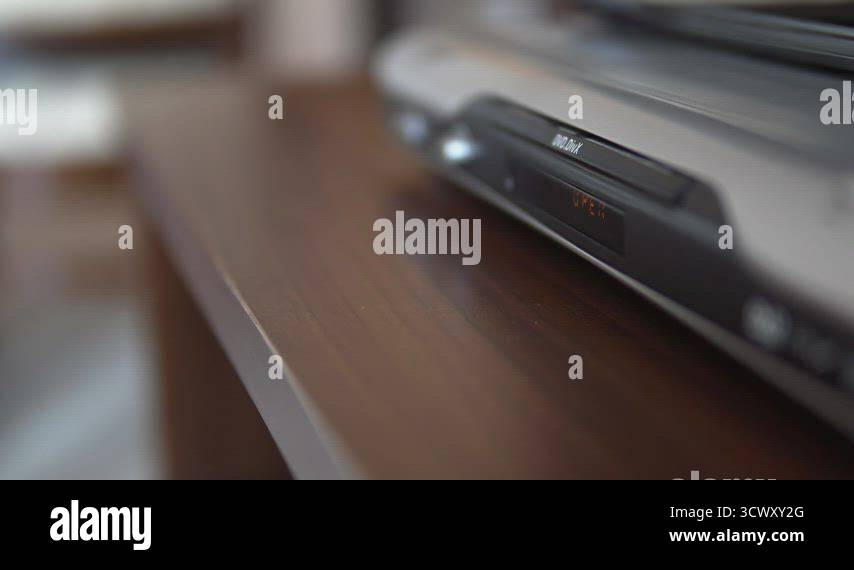 unloading laser disc from the DVD/CD player. Man of hand removes laser ...