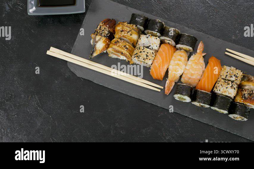 Variety mix of traditional sushi rolls on black stone plate Stock Video ...