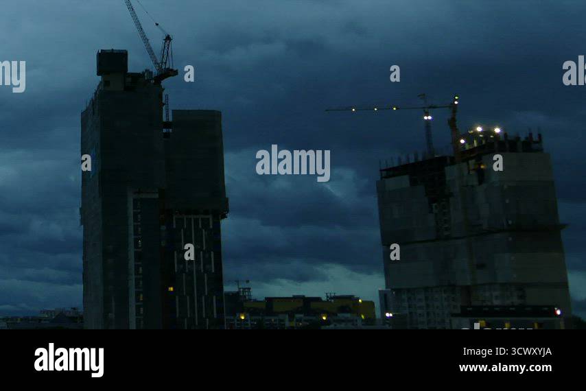 timelapse of tower crane and high-rise building under construction at ...