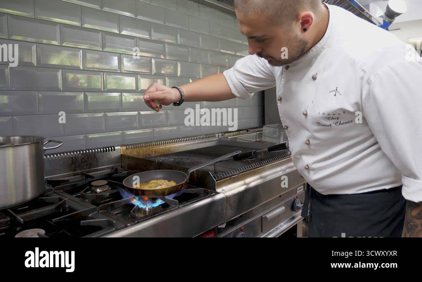 Male cook in restaurant kitchen squeezing a lime Stock Video Footage ...