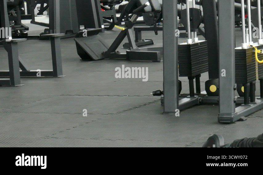 young man lift dumbbell in gym. bodybuilder male working out in fitness ...