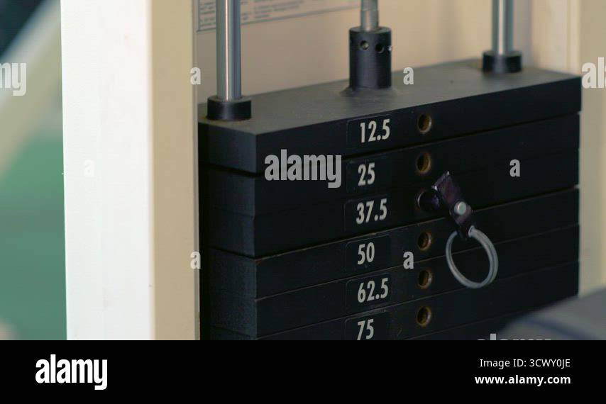 Close up on black weights attached to machine Stock Video Footage - Alamy