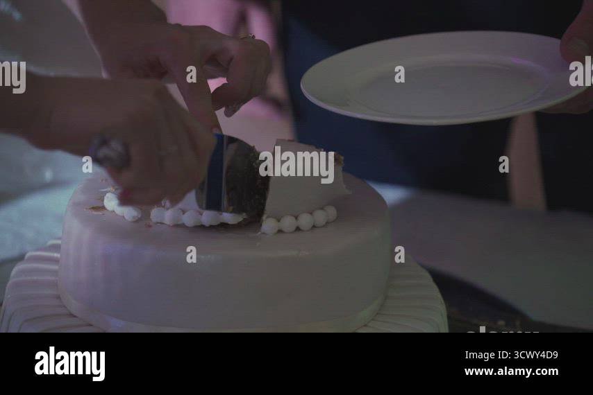 Woman cutting celebration cake Stock Video Footage - Alamy