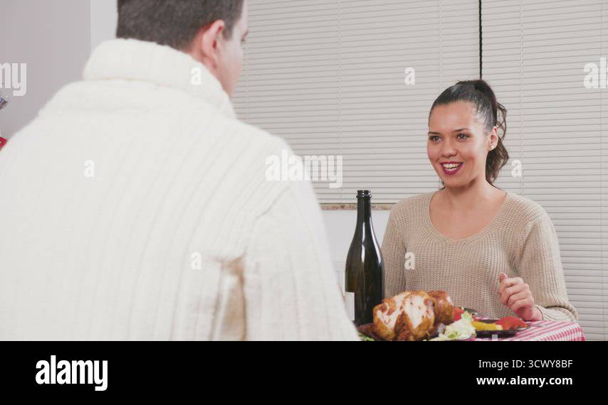 Woman at the table with her husband enjoying a Christmas meal Stock ...