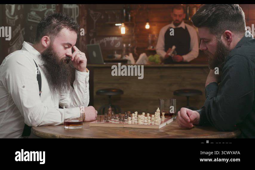 Two stylish hipsters with beards playing a friendly chess game Stock ...