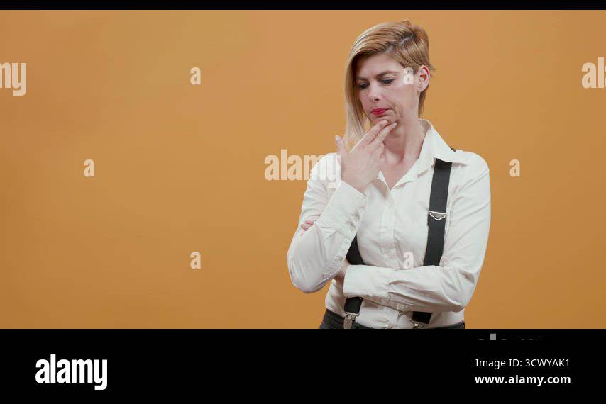 Portrait of a young pretty woman being confused and thinking over something Stock Video Footage ...