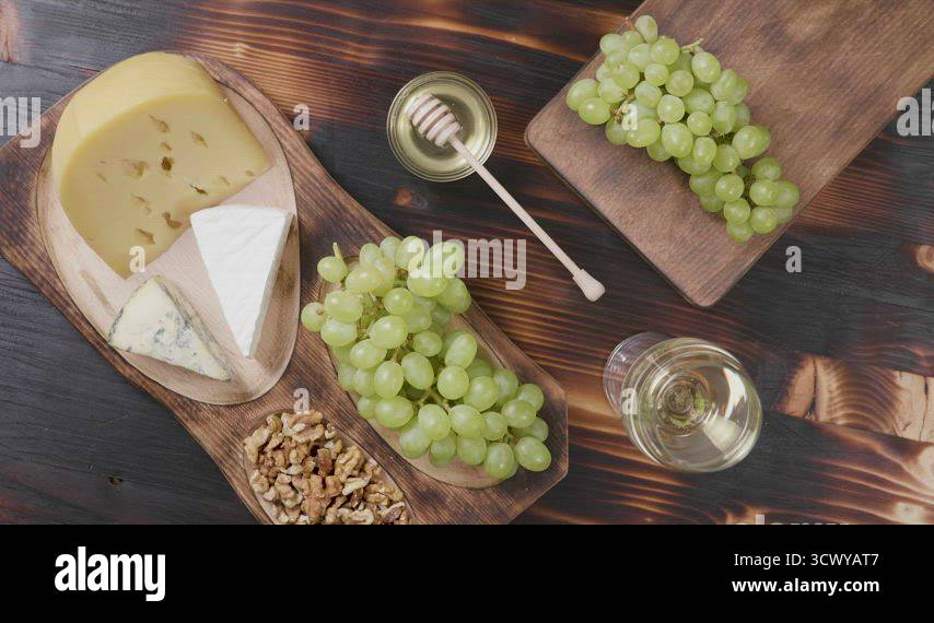 Brie, gouda and roquefort cheese in a beautiful composition with white ...