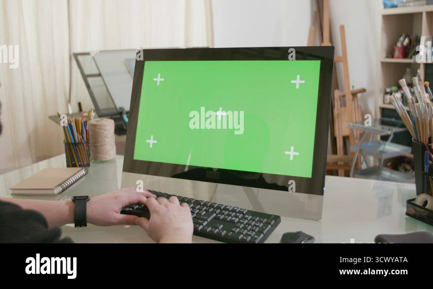 Slow panning shot of male hands typing a text in front of a green ...