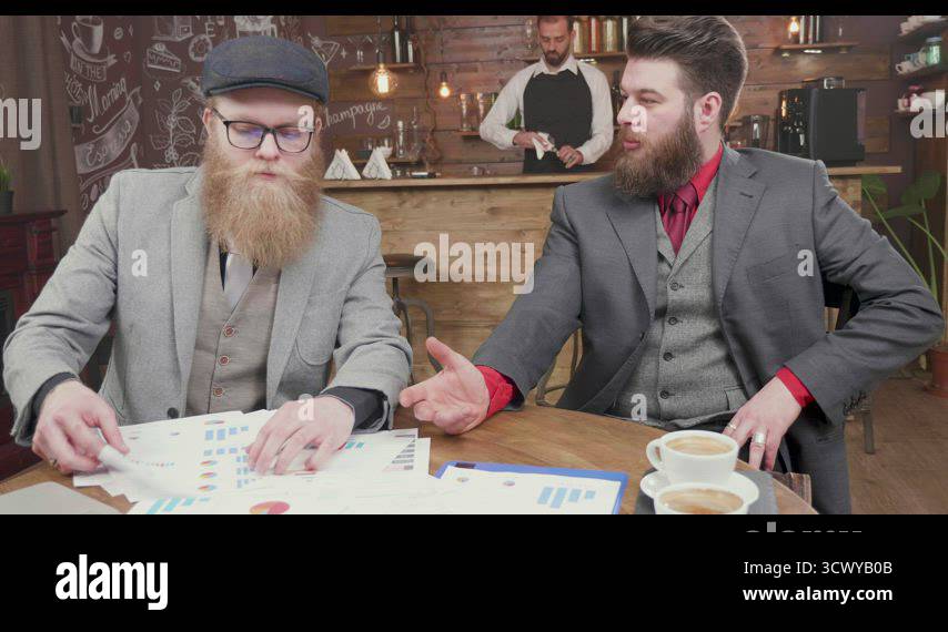 Business colleagues serve coffee and discuss new projects Stock Video ...