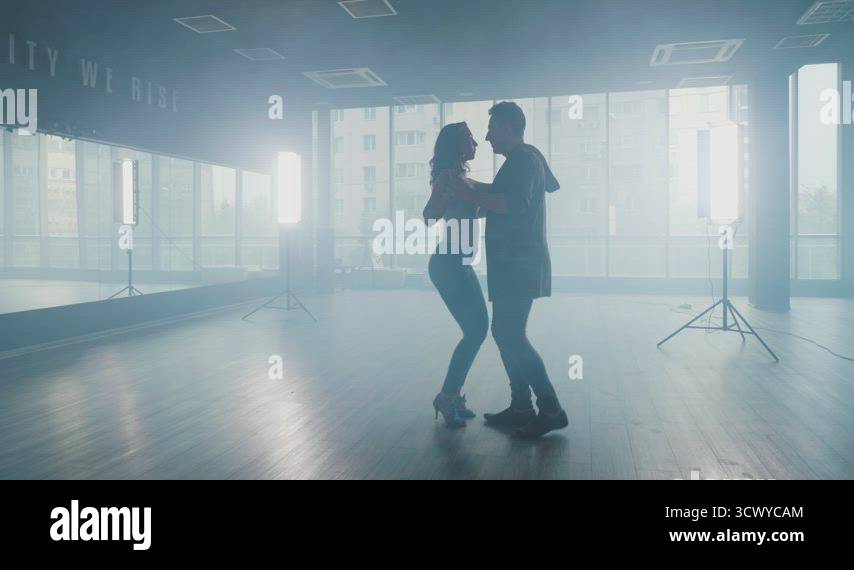 Silhouette of dance partners dancing kizomba in a large studio Stock Video Footage - Alamy