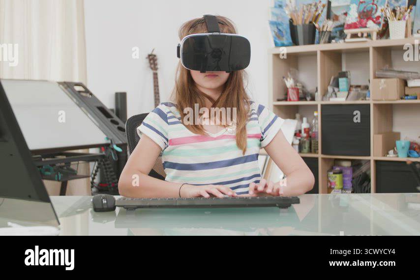 Teenage kid typing a text on her keyboard and wearing a vr headset ...