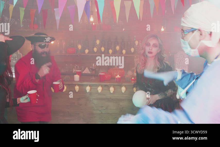 Drunk friends have fun and dance at a halloween party disguised as ...