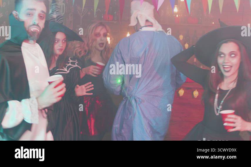Young people drink and dance at a halloween party in a local pub Stock ...
