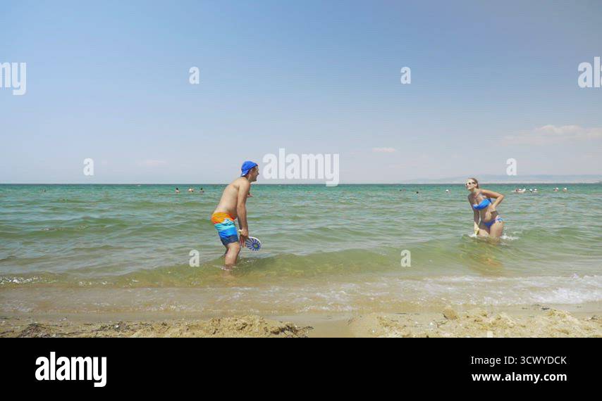 Young couple enjoying ping pong game in the sea Stock Video Footage - Alamy