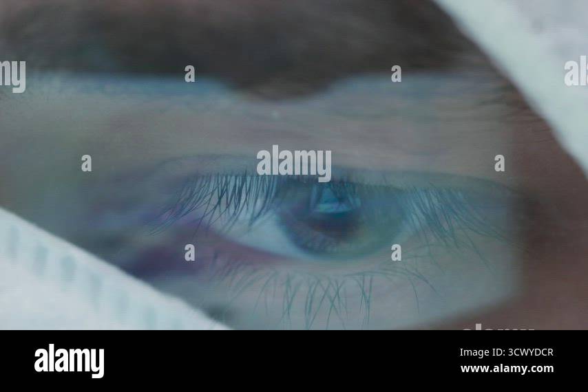 Extreme close up shot of scientist eye with a brain reflection in it ...