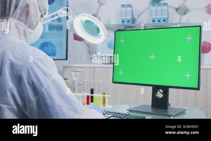 Chemist in white coverall working on green screen computer Stock Video ...