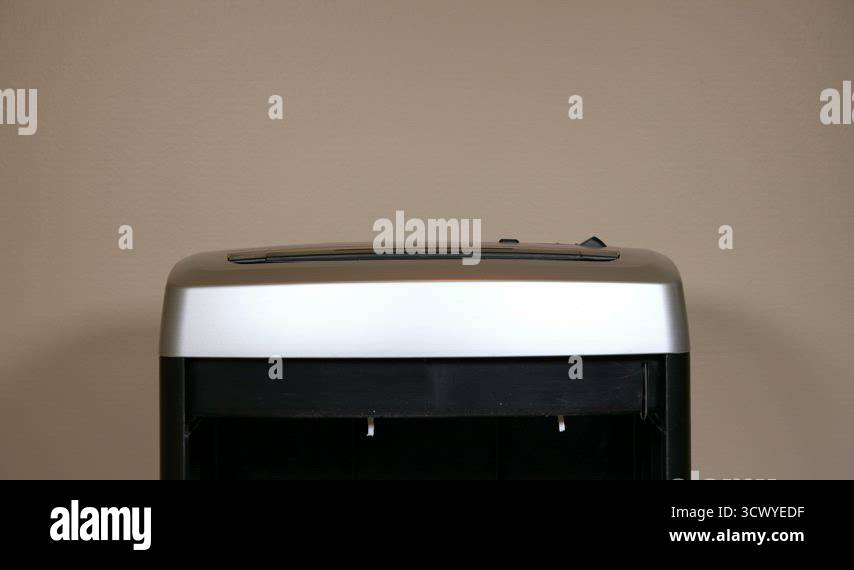 Static shot of mans hand shredding a paper vote into a shredder in ...