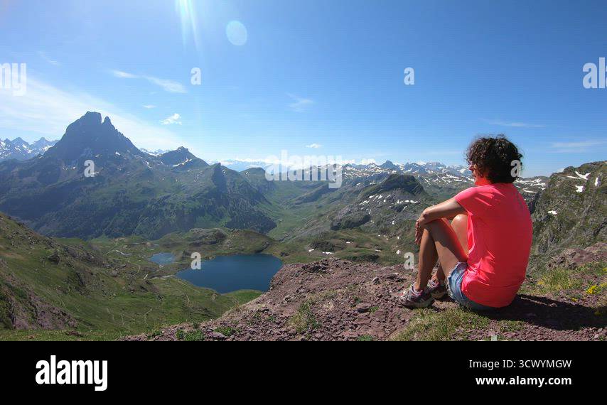 hiking woman looking Pic du Midi Ossau in the french Pyrenees mountains ...