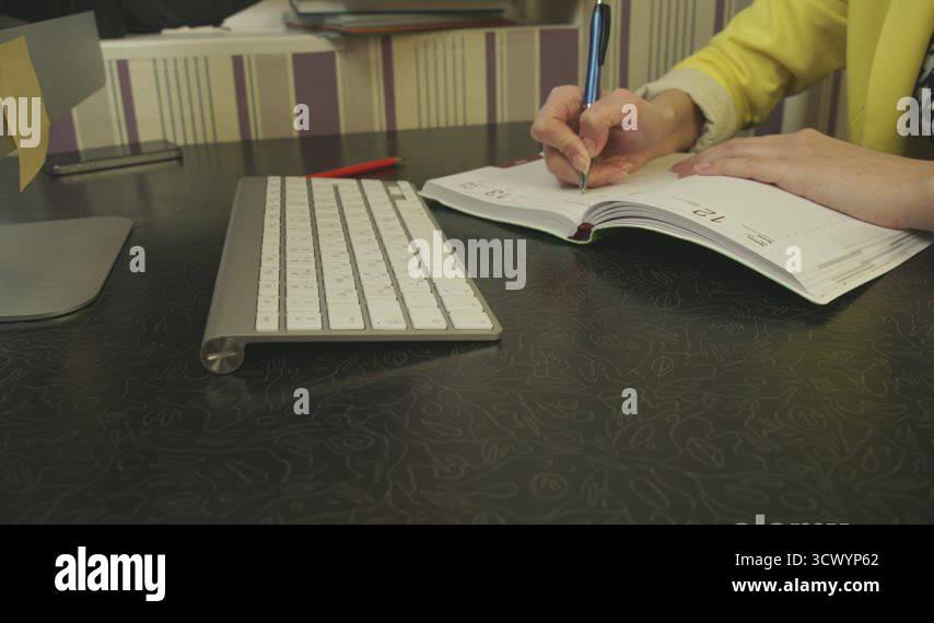 A student in a yellow jacket writing in a notebook Stock Video Footage ...