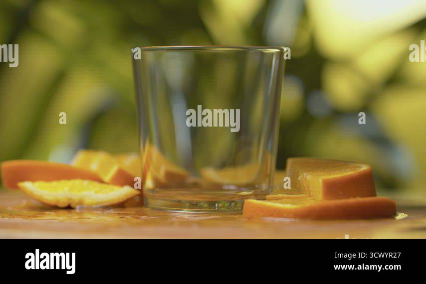Splash of orange juice falling into a glass Stock Video Footage - Alamy
