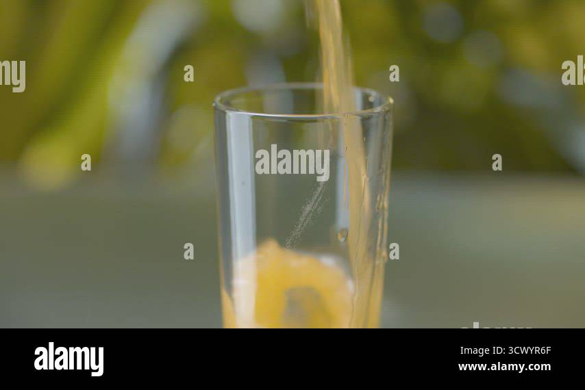 Fizzy orange drink pouring into a glass Stock Video Footage - Alamy
