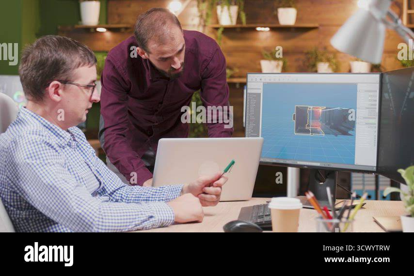 Graphic designer in game industry sitting at his office Stock Video ...