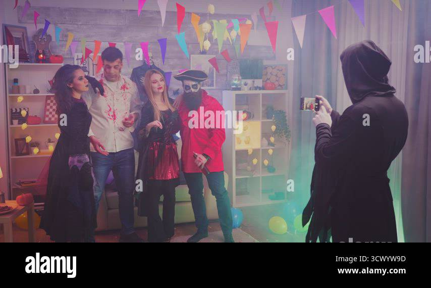 Spooky characters taking a group photo Stock Video Footage - Alamy