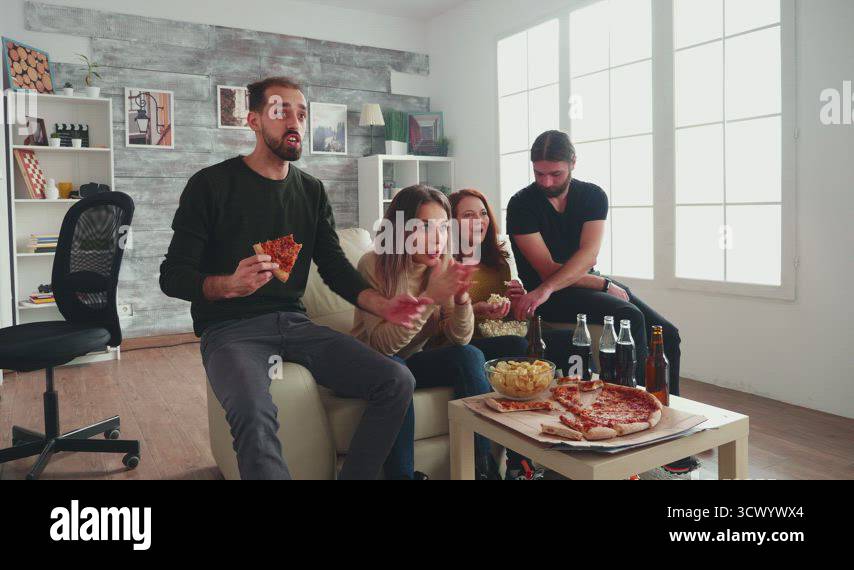 Young man holding a slice of pizza throwing himself on the floor Stock ...