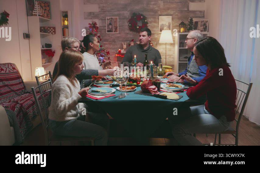 Gathering of big family around the table with delicious food Stock ...
