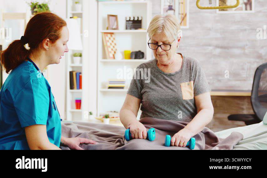 Revealing shot of female nurse helping an elderly woman to recover her ...